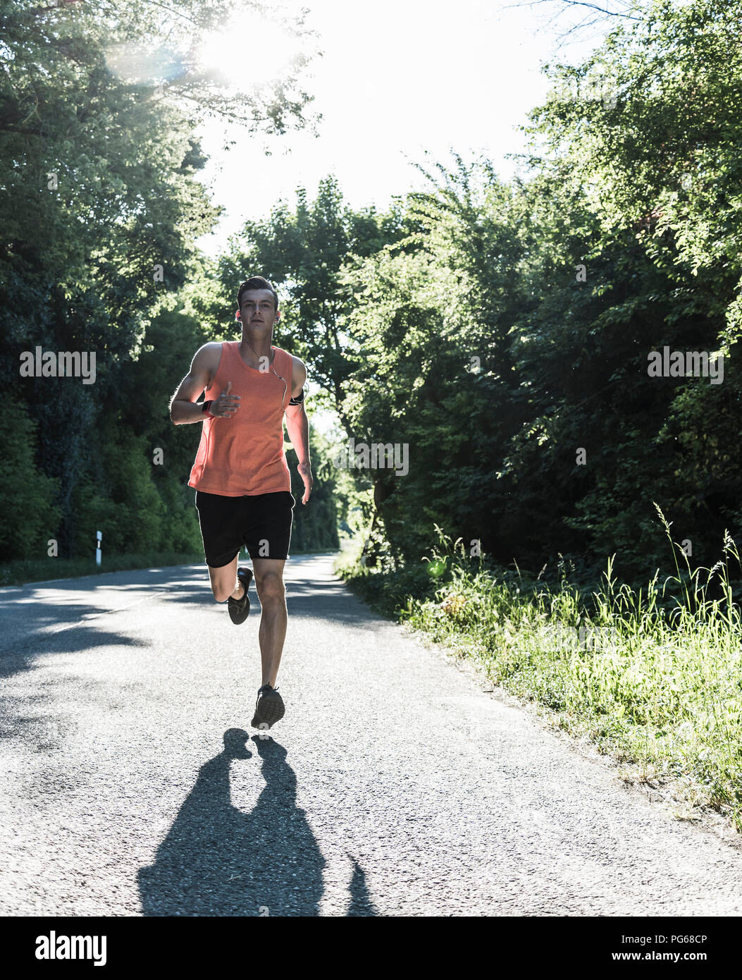 Young man running in park hi-res stock photography and images - Alamy