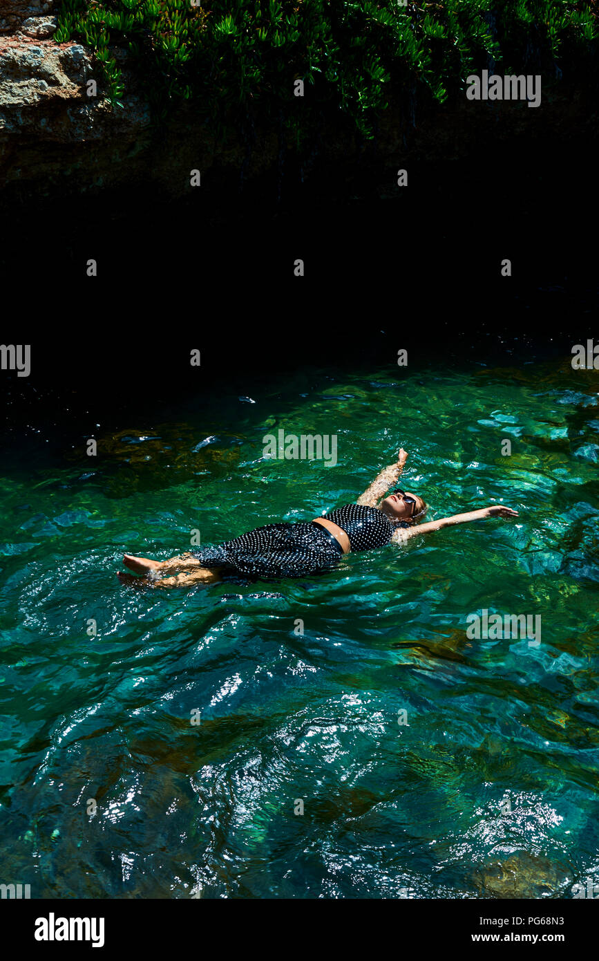 Greece, Crete, Hersonissos, woman in dress floating in sea Stock Photo ...