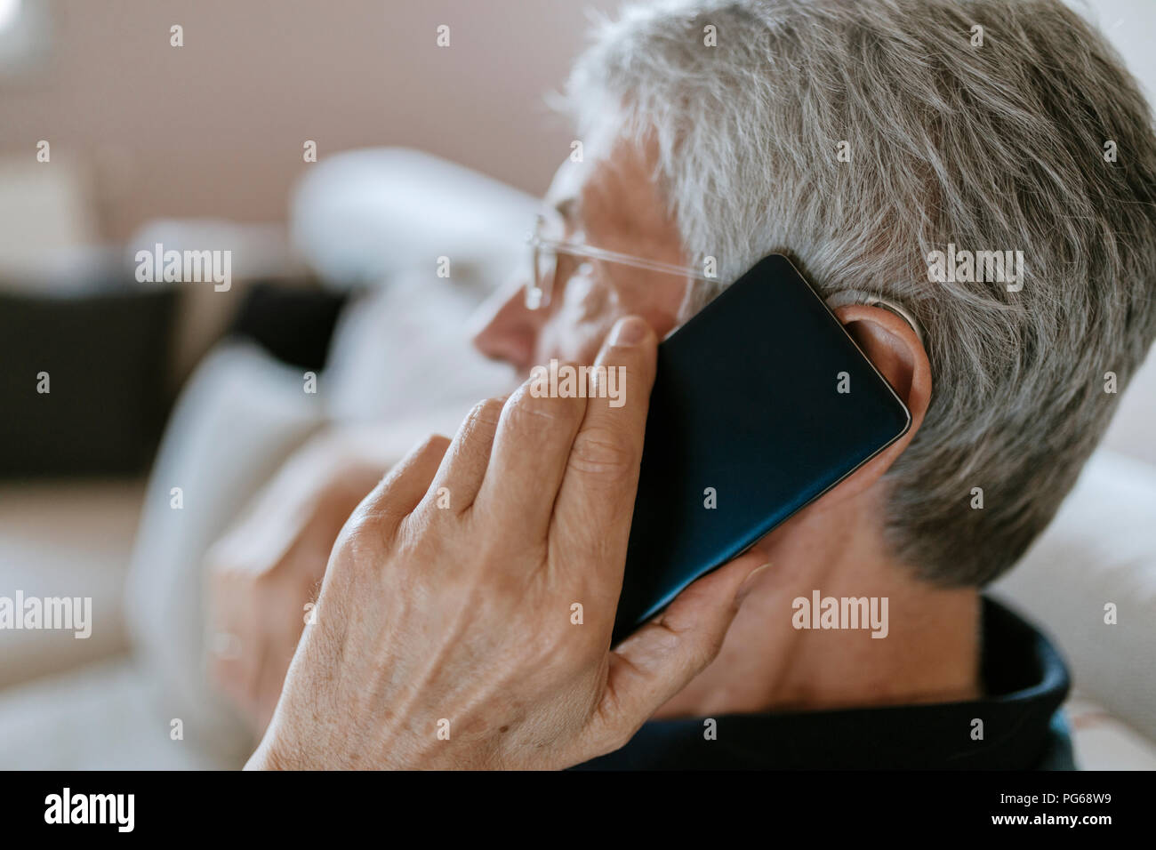 Man holding cell phone ear hi-res stock photography and images - Alamy