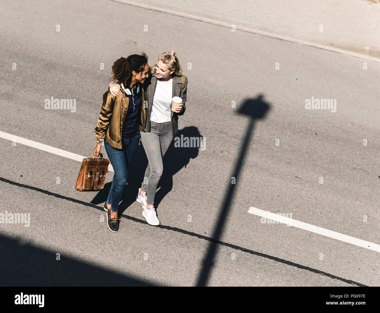Young women walking empty road hi-res stock photography and images - Alamy