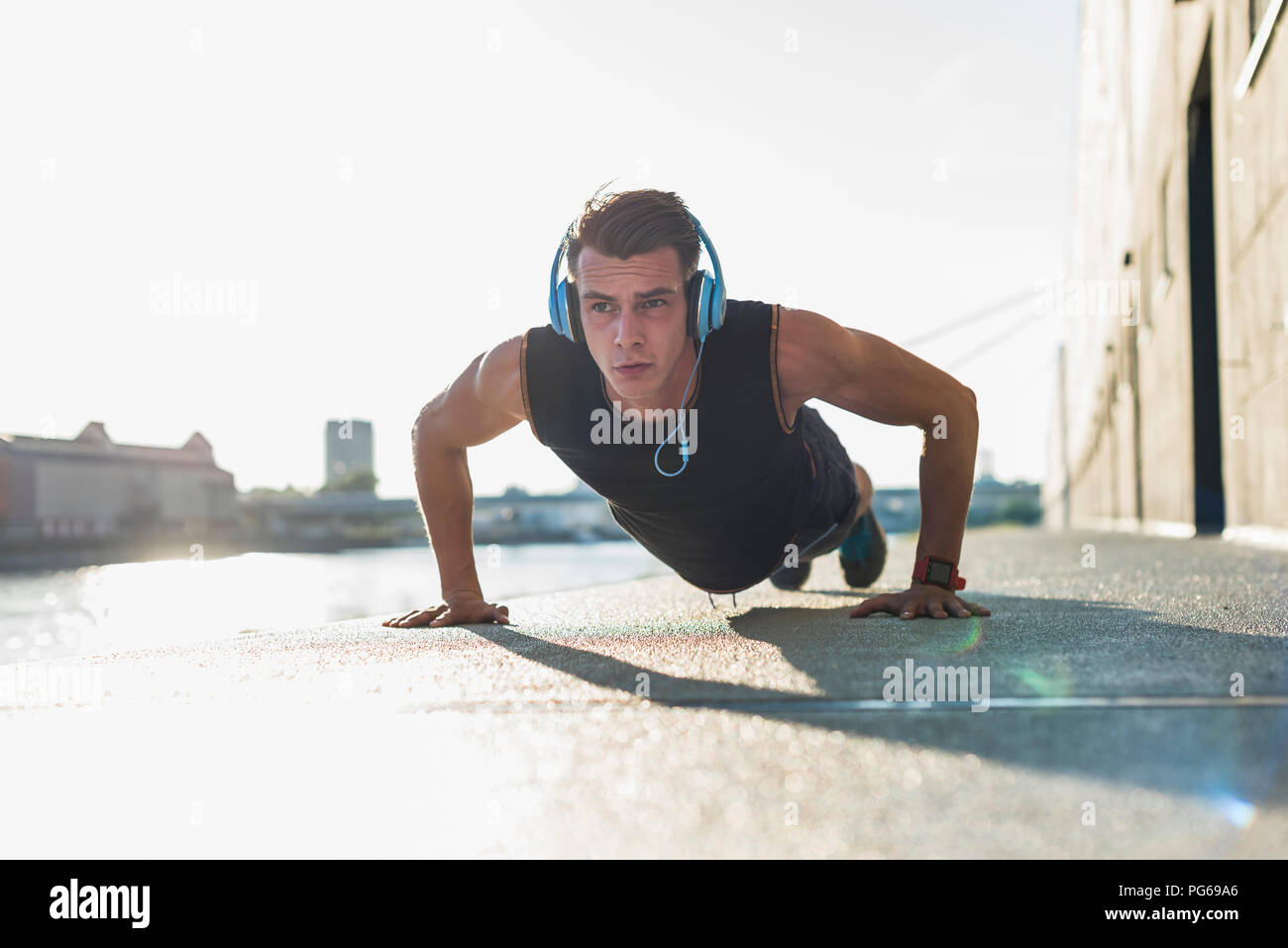 Fit athlete doing push ups at the river Stock Photo - Alamy