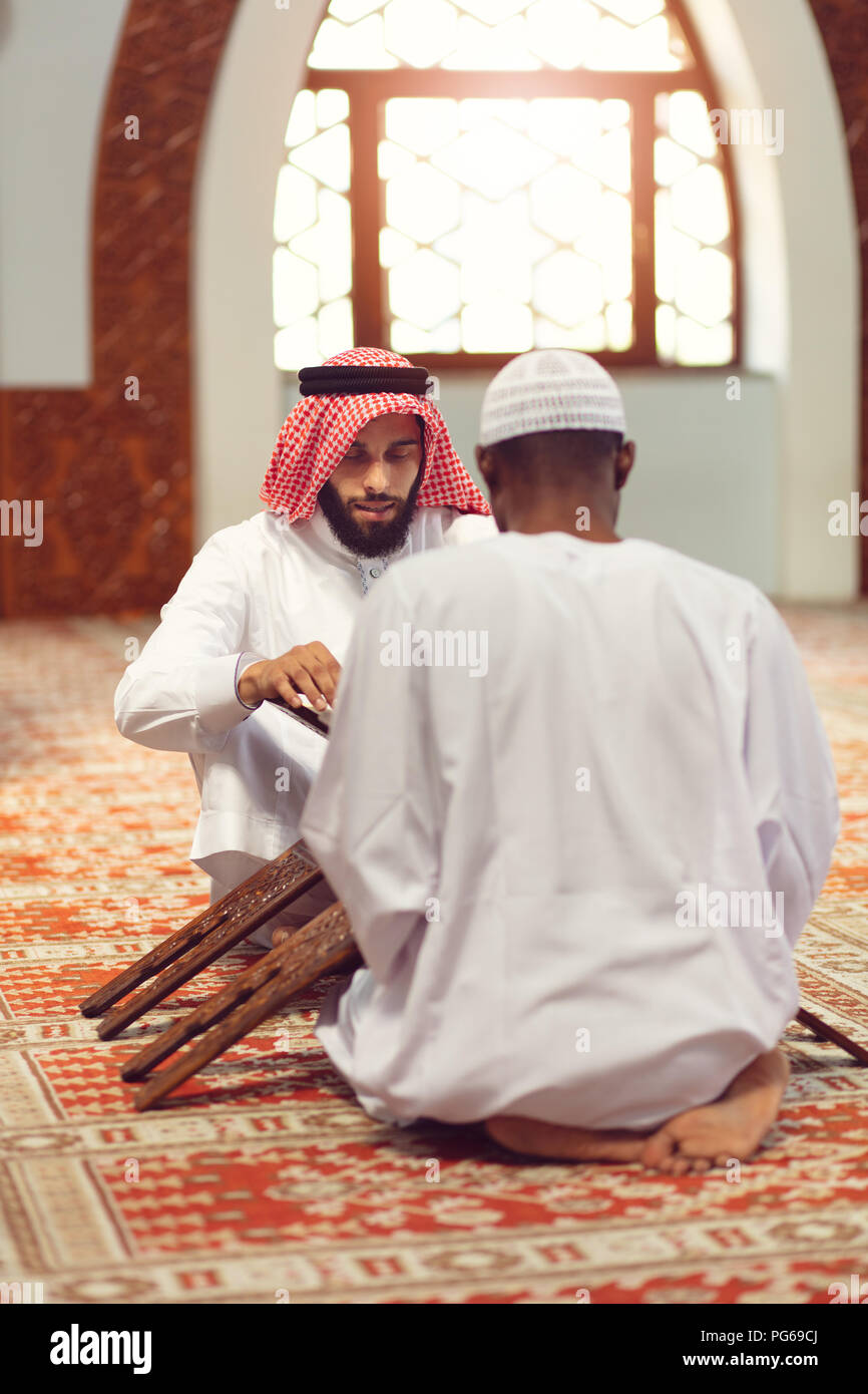Two religious muslim man praying together inside the mosque Stock Photo ...