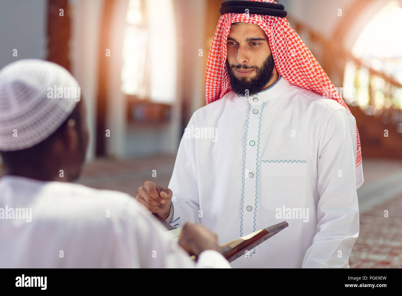 Two religious muslim man praying together inside the mosque Stock Photo ...