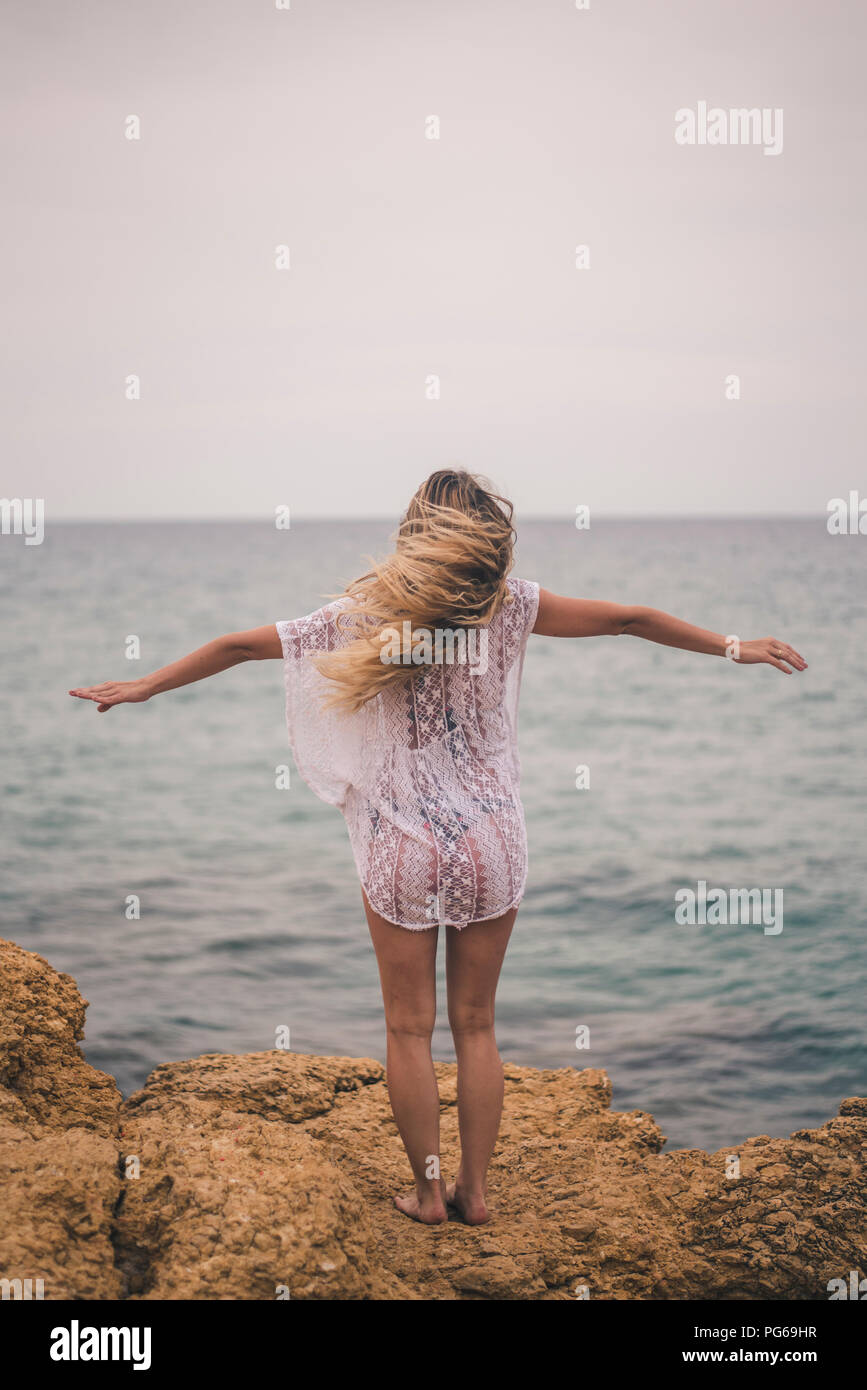 Rear view of woman with wind blowing hi-res stock photography and ...