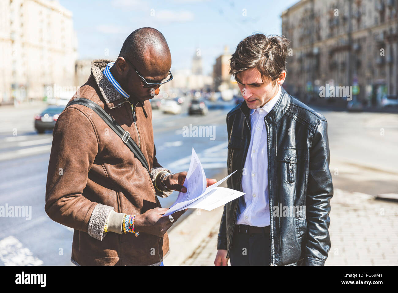 Two young people looking documents hi-res stock photography and images ...