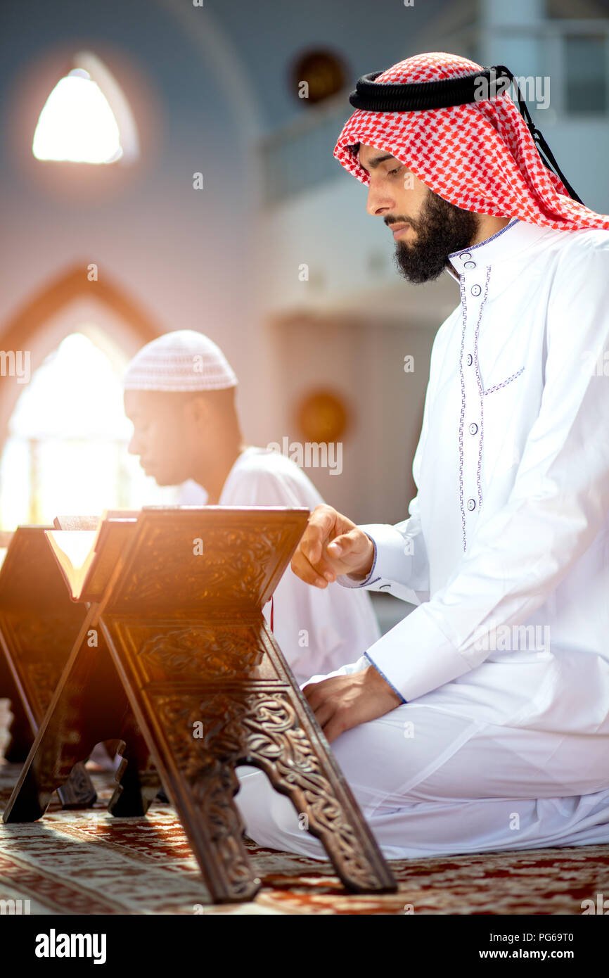 Two religious muslim man praying together inside the mosque Stock Photo ...