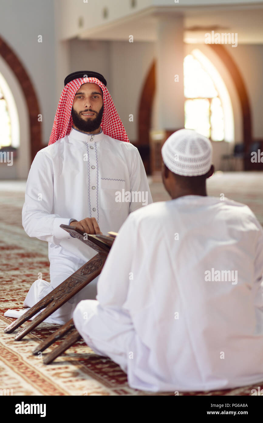 Two religious muslim man praying together inside the mosque Stock Photo ...