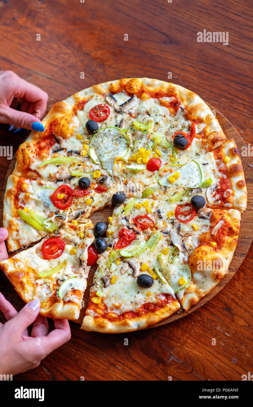 Mock up freelancer workplace. Tablet PC, cell phone and pizza. Top view ...