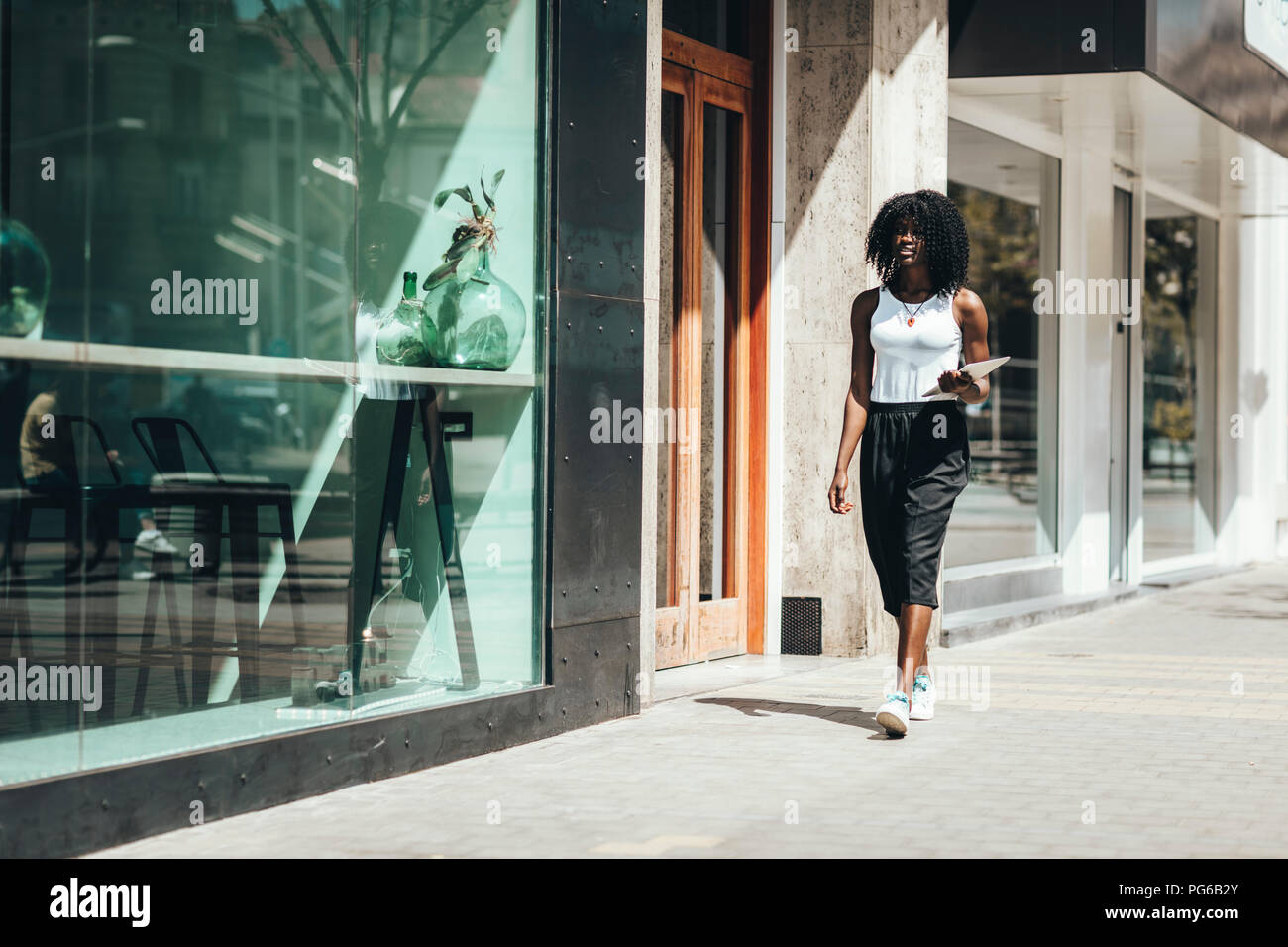 Woman walking pavement hi-res stock photography and images - Alamy