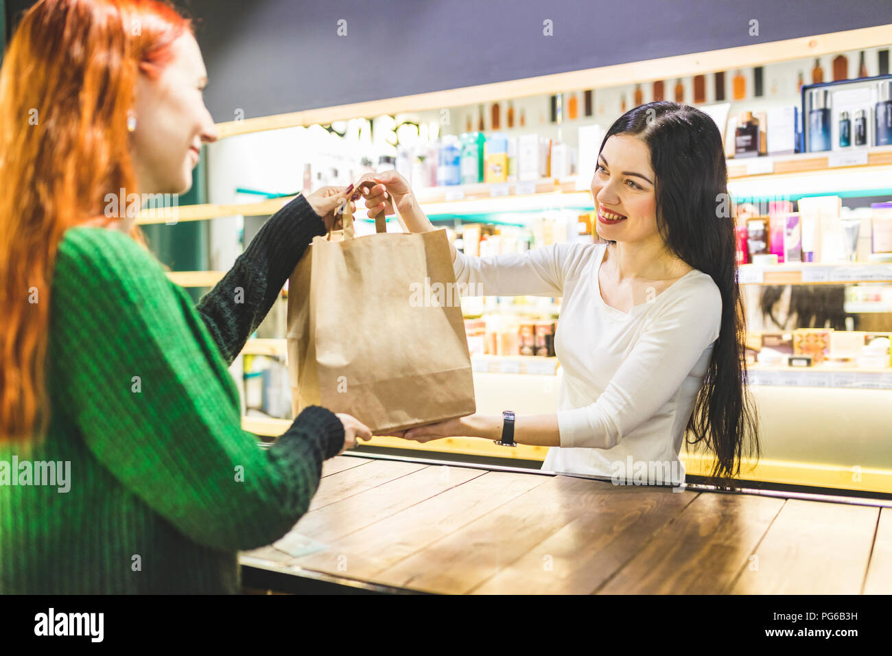 Handing a bag hi-res stock photography and images - Alamy