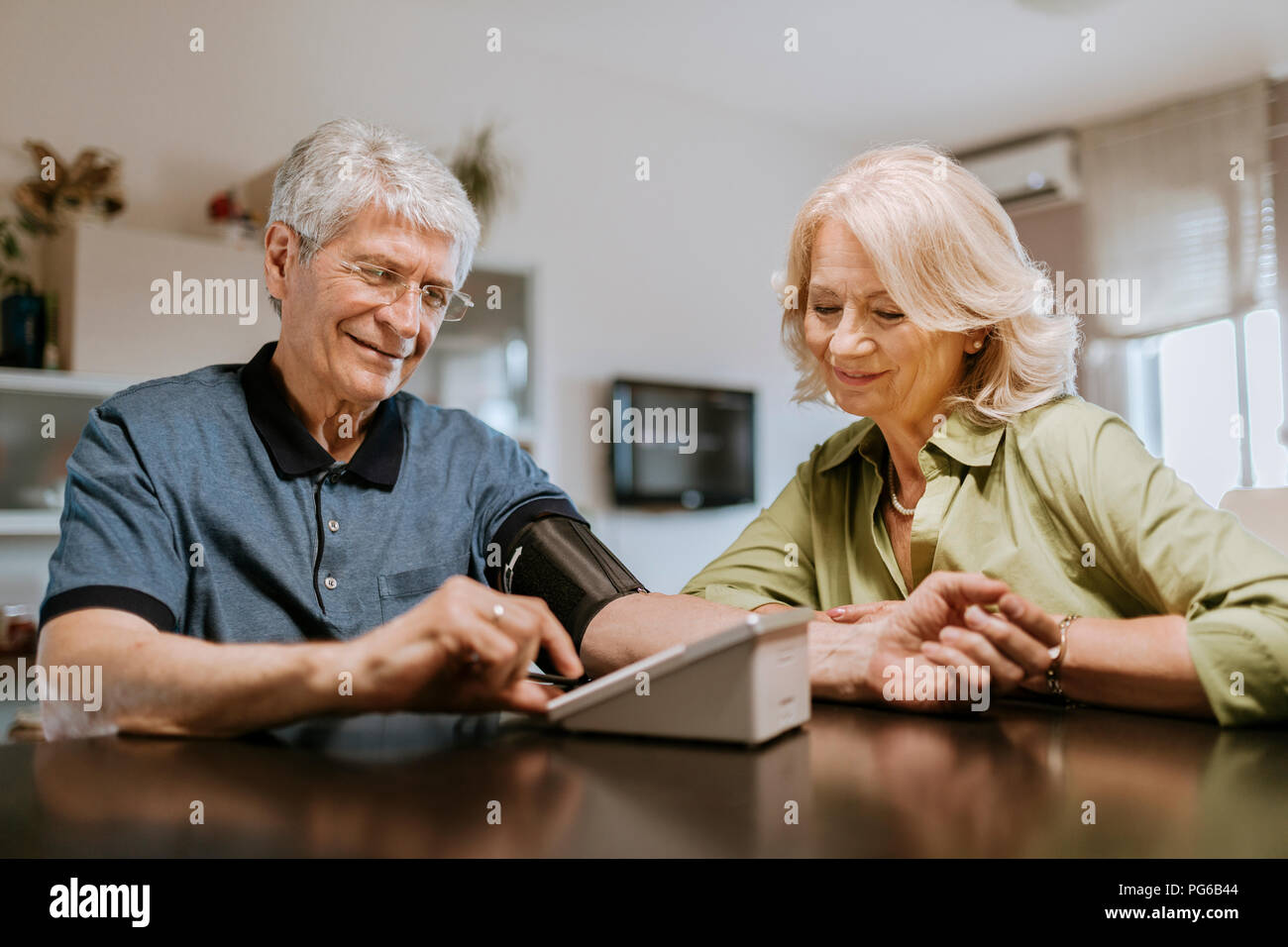 Senior couple taking blood pressure Stock Photo - Alamy
