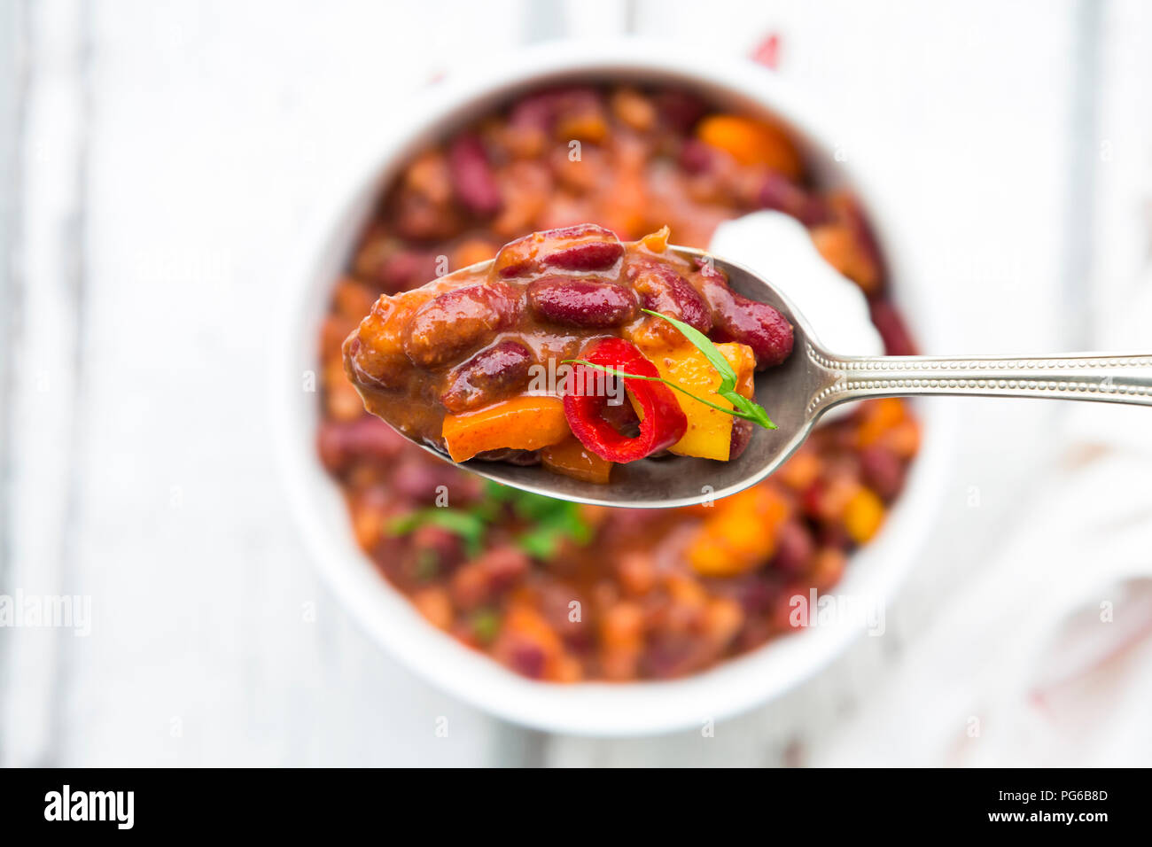 Spoon of Chili con Carne with fresh coriander Stock Photo - Alamy