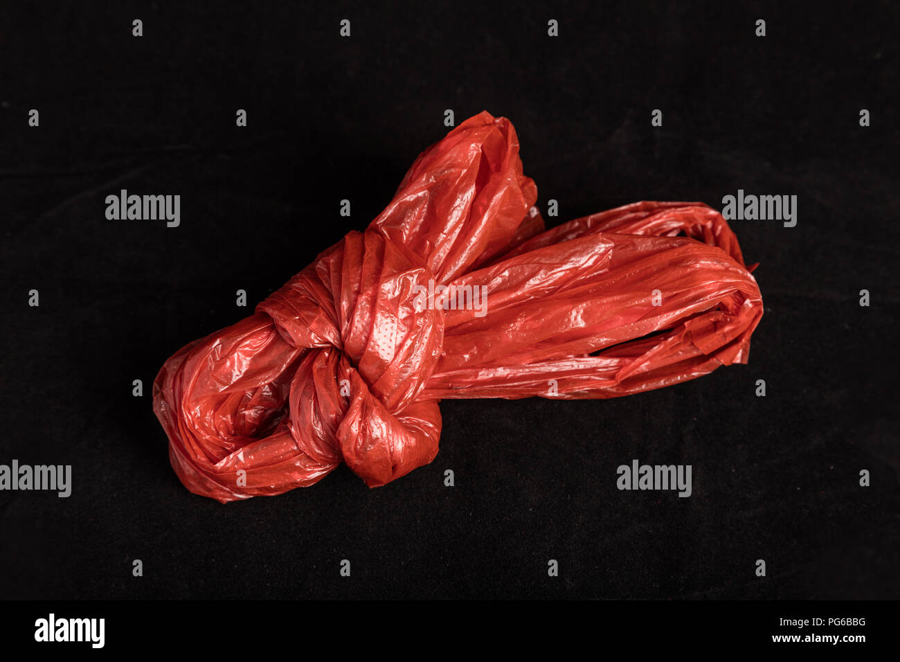 Red Plastic Bag close up with black background Stock Photo - Alamy