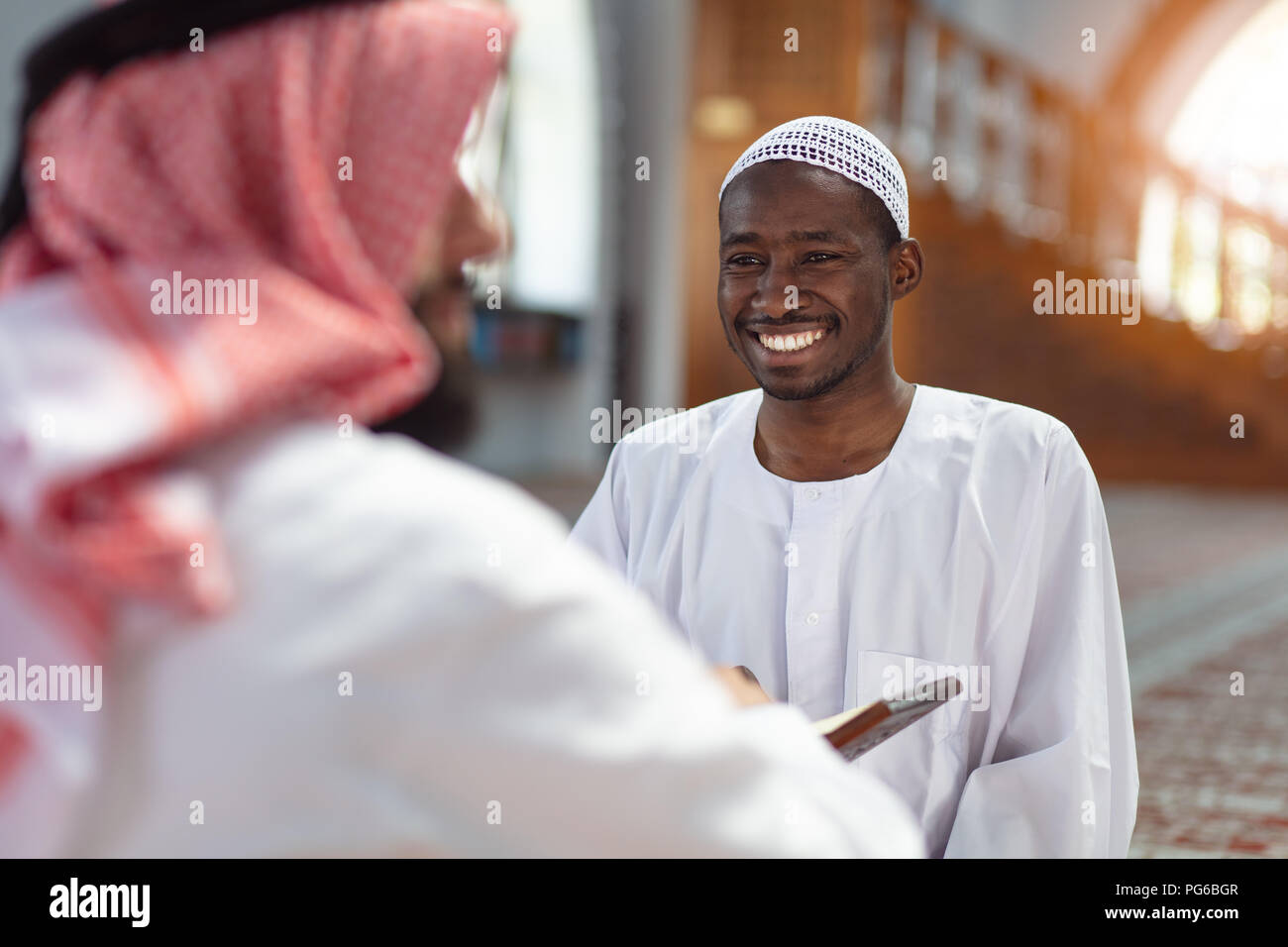 Two religious muslim man praying together inside the mosque Stock Photo ...