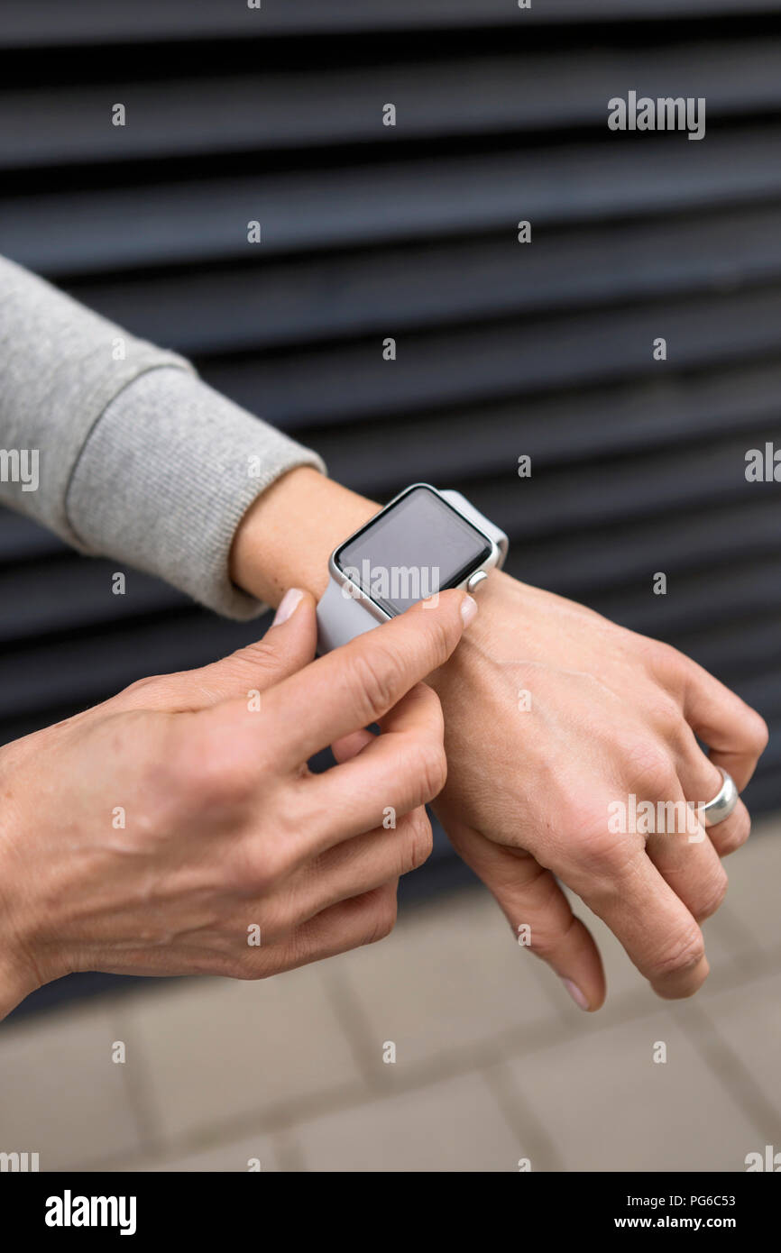 Woman's hand adjusting settings of smartwatch, close-up Stock Photo - Alamy