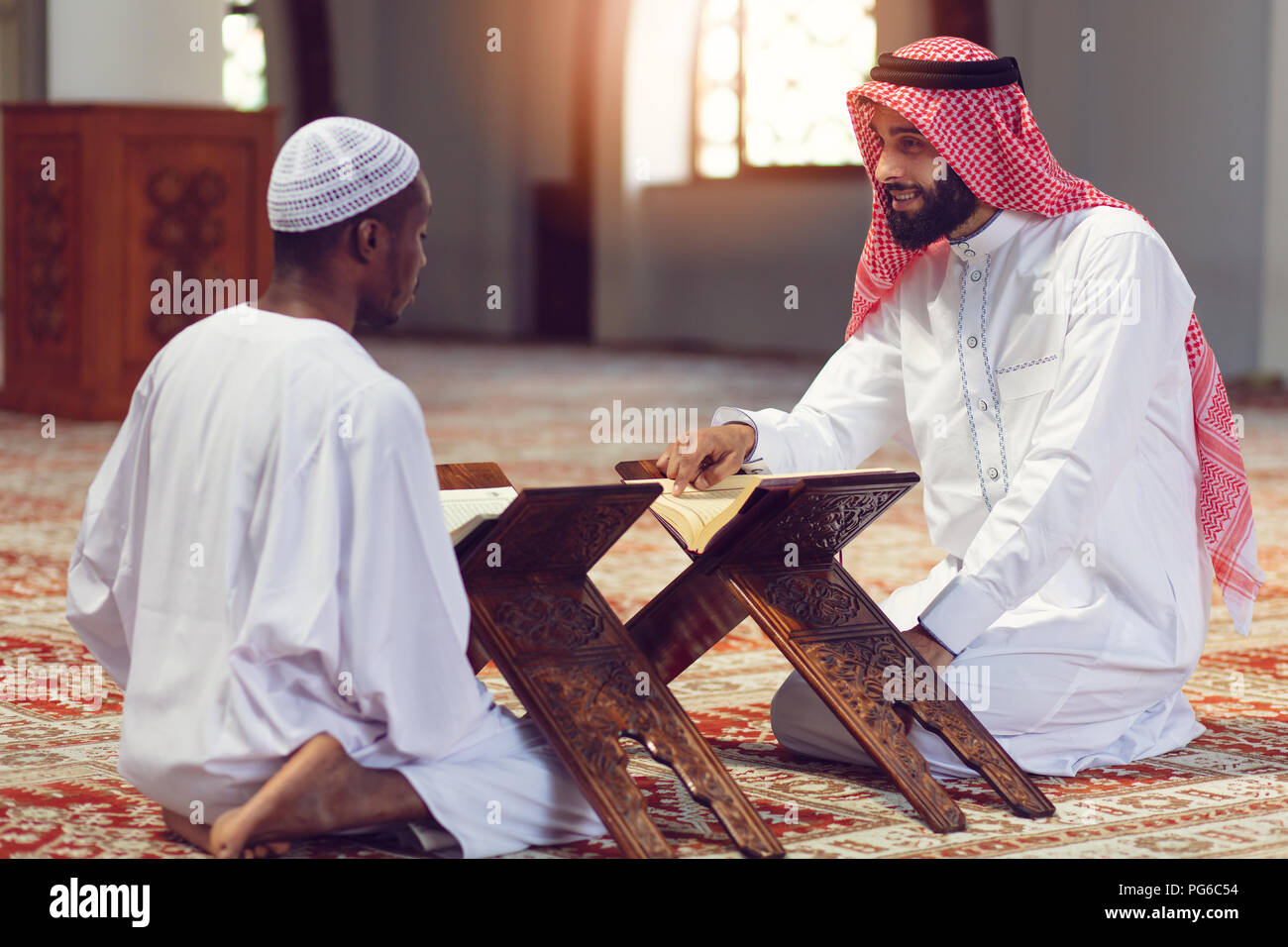 Two religious muslim man praying together inside the mosque Stock Photo ...