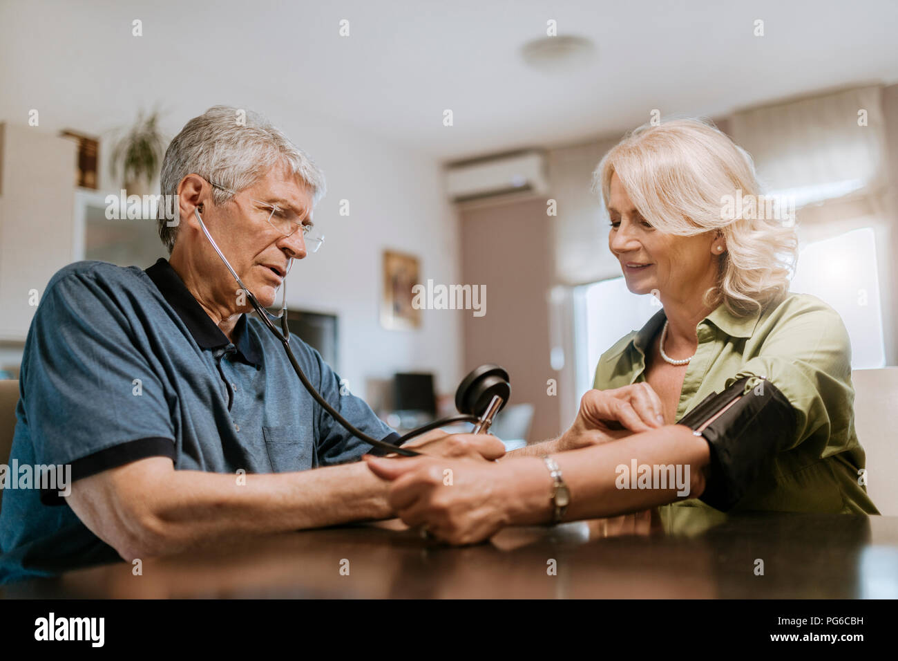 Senior couple taking blood pressure Stock Photo - Alamy