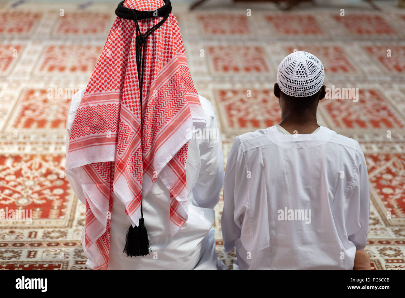 Two religious muslim man praying together inside the mosque Stock Photo ...