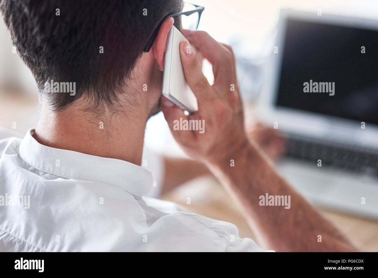 Back view of businessman on the phone Stock Photo - Alamy