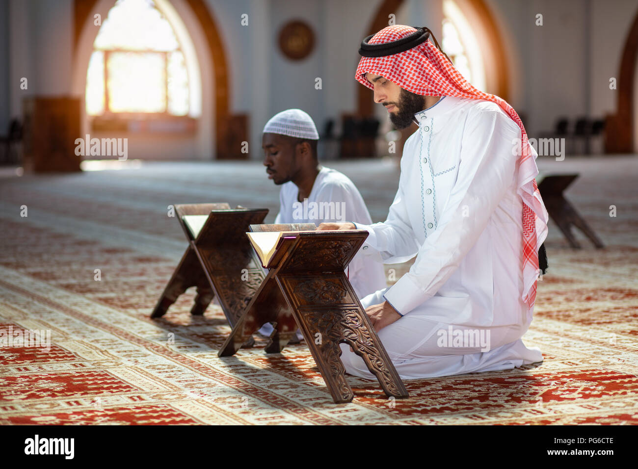 Two religious muslim man praying together inside the mosque Stock Photo ...