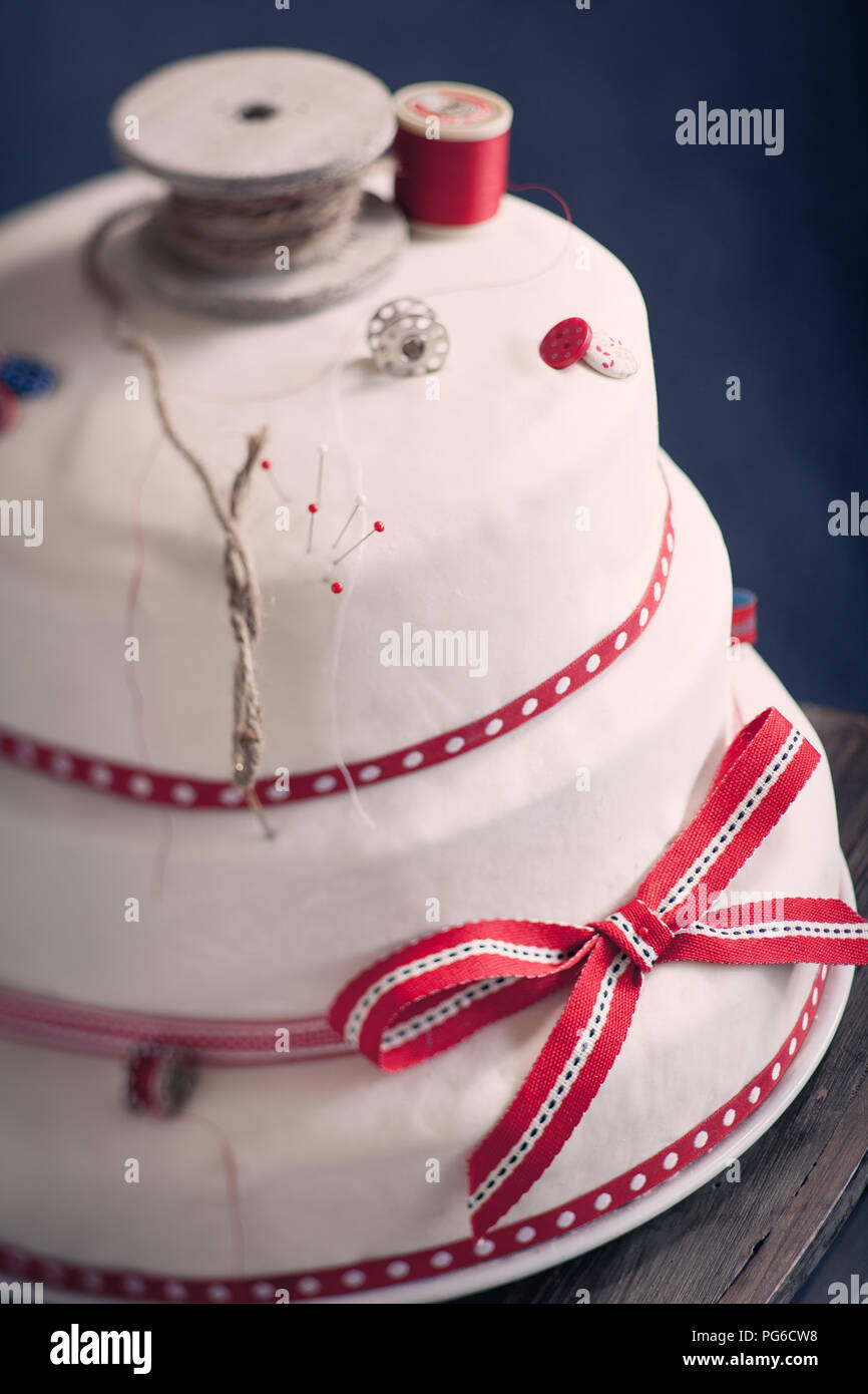 Beautiful wedding cake with ribbon needle and yarn Stock Photo - Alamy