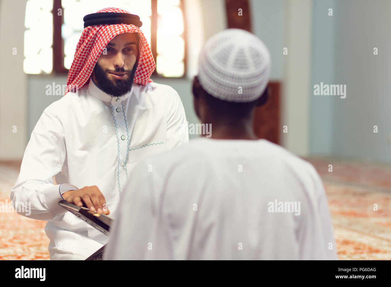 Two religious muslim man praying together inside the mosque Stock Photo ...