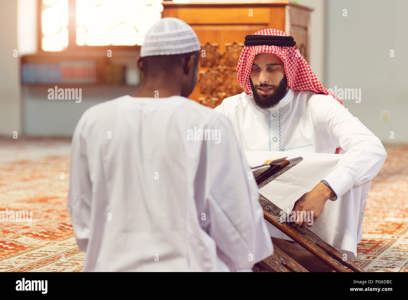 Two religious muslim man praying together inside the mosque Stock Photo ...