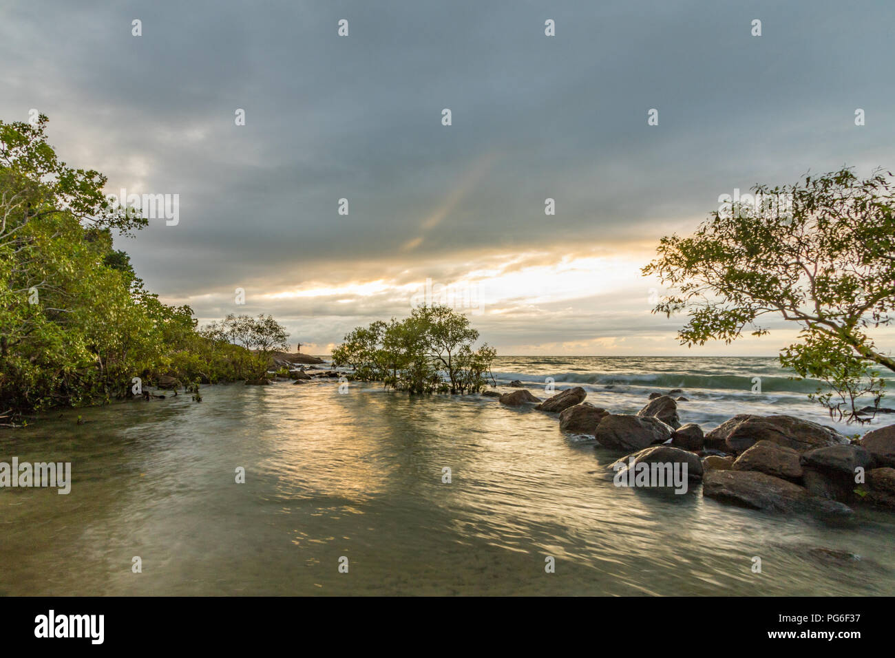 Cloudy sunrise over natural ocean rock pool Stock Photo - Alamy