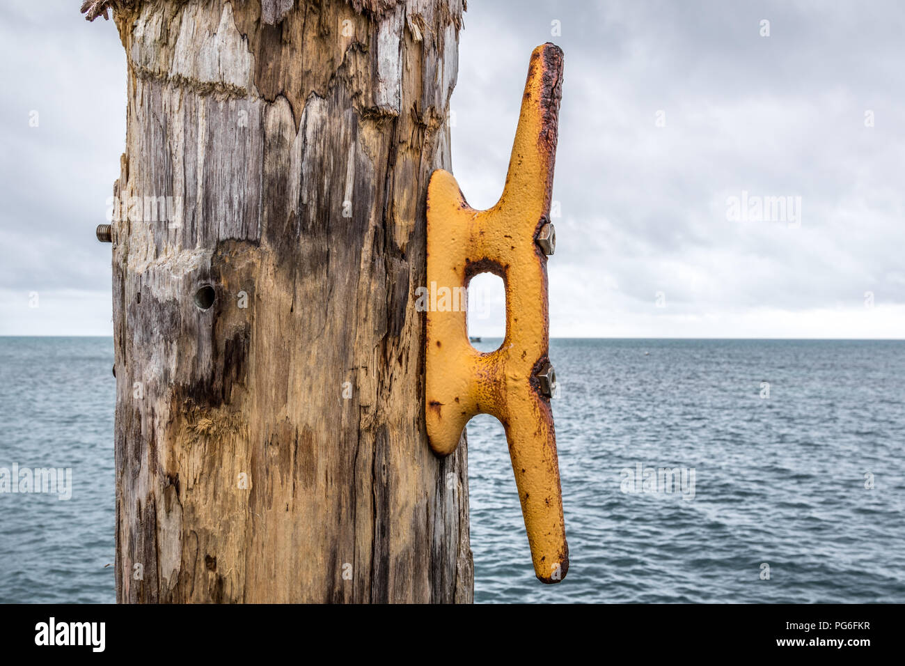 Nautical cleat on worn timber pylon Stock Photo - Alamy
