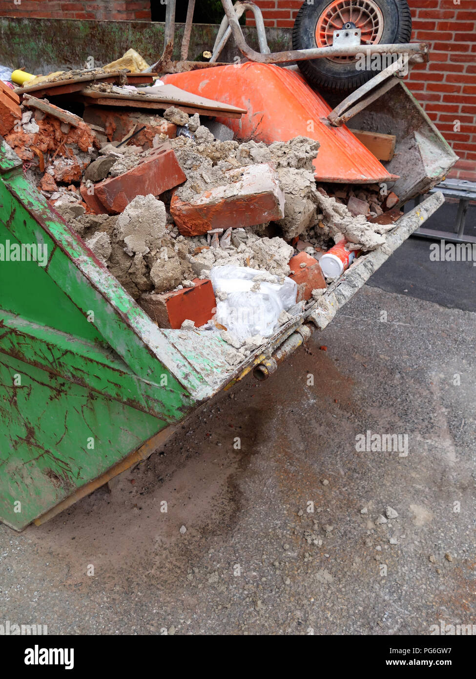 builders skip almost full outside building Stock Photo - Alamy