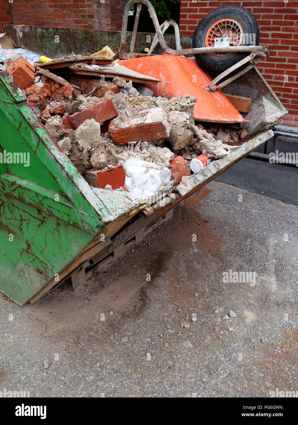 builders skip almost full outside building Stock Photo - Alamy