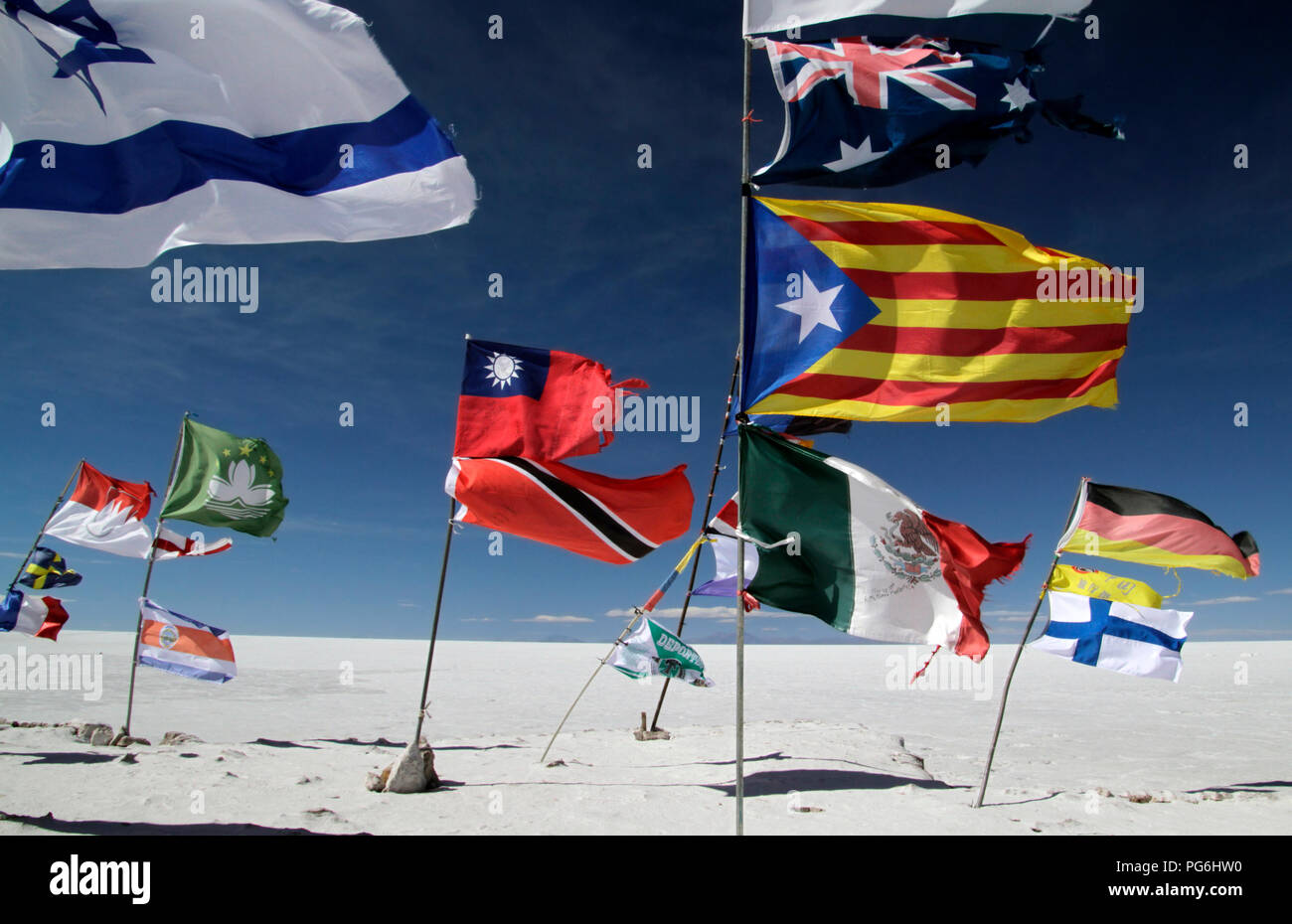 Various national flags in the salt flats of Uyuni, Bolivia Stock Photo ...