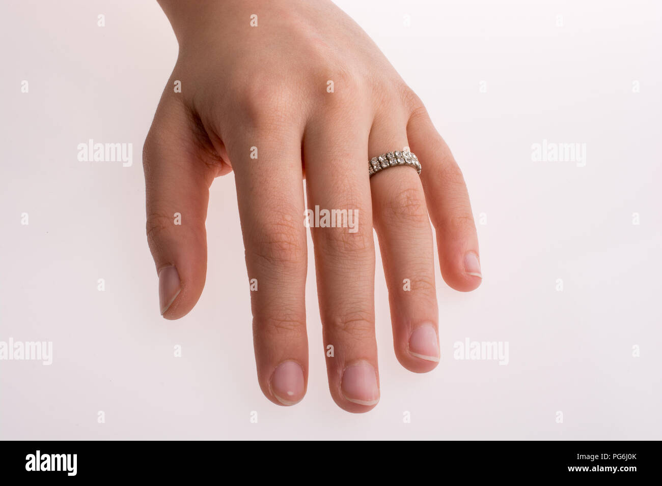 Hand wearing a ring on a white background Stock Photo - Alamy