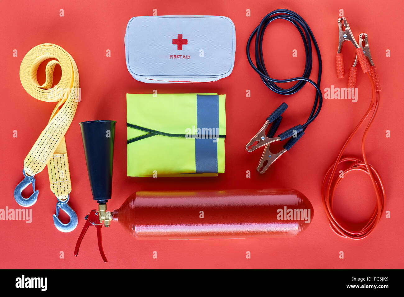 top view of fire extinguisher, first aid kit and jump start cables on ...