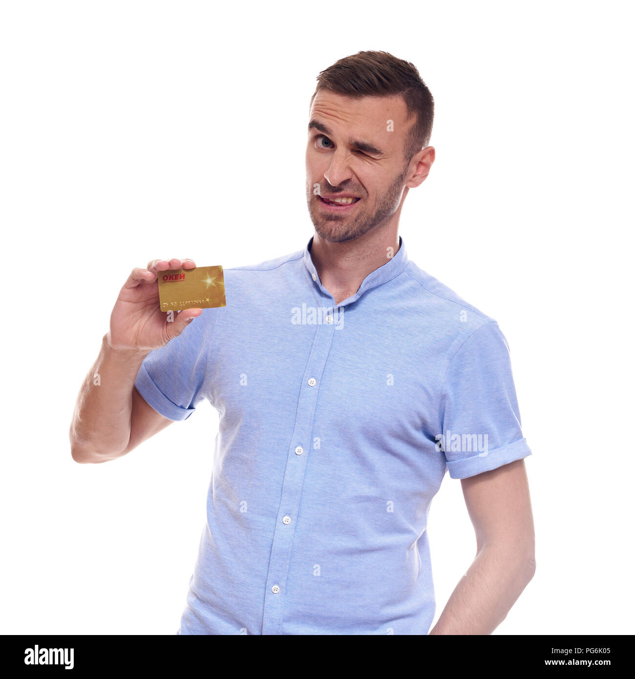 Happy smiling young man showing credit card isolated on white ...