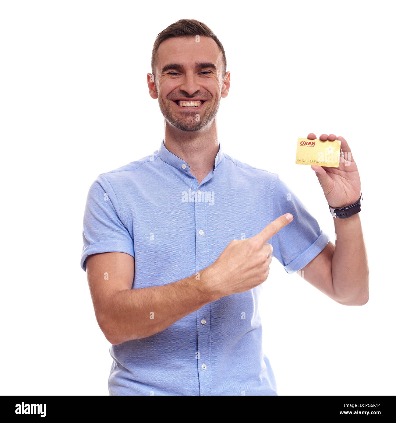 Happy smiling young man showing credit card isolated on white ...