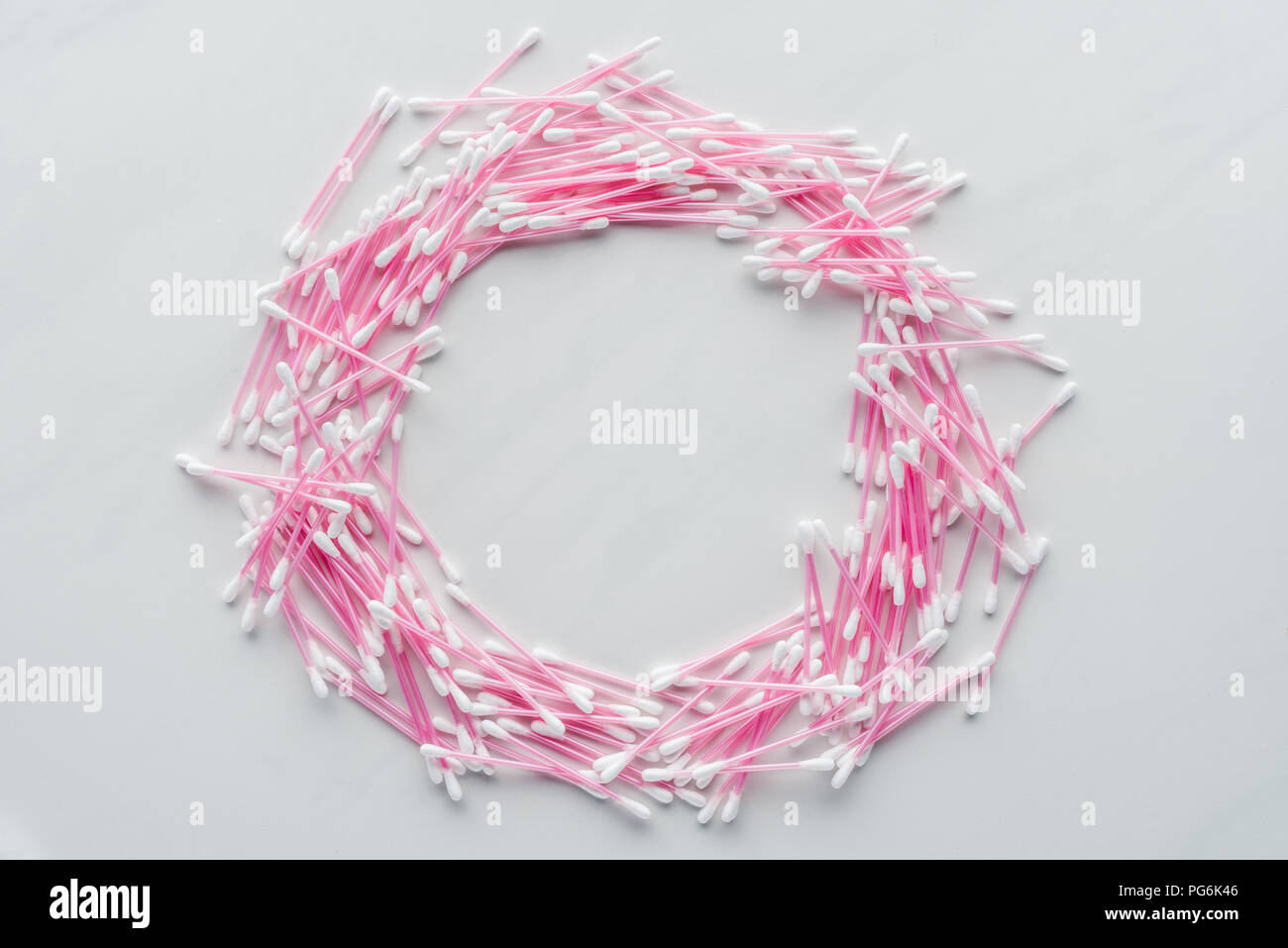 top view of cotton swabs in shape of circle isolated on white, beauty ...