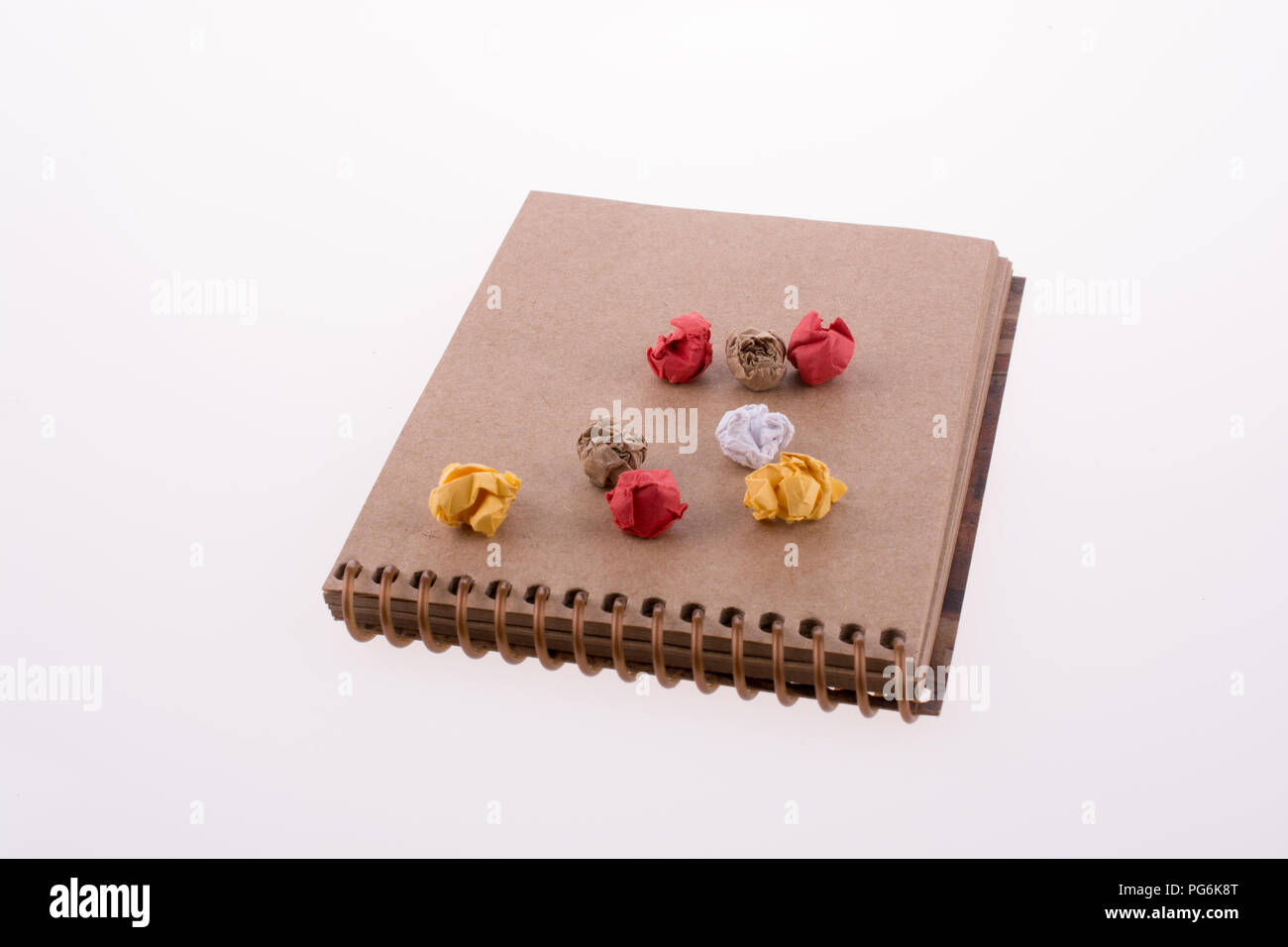 Colorful crumbled paper on a notebook on a white background Stock Photo ...