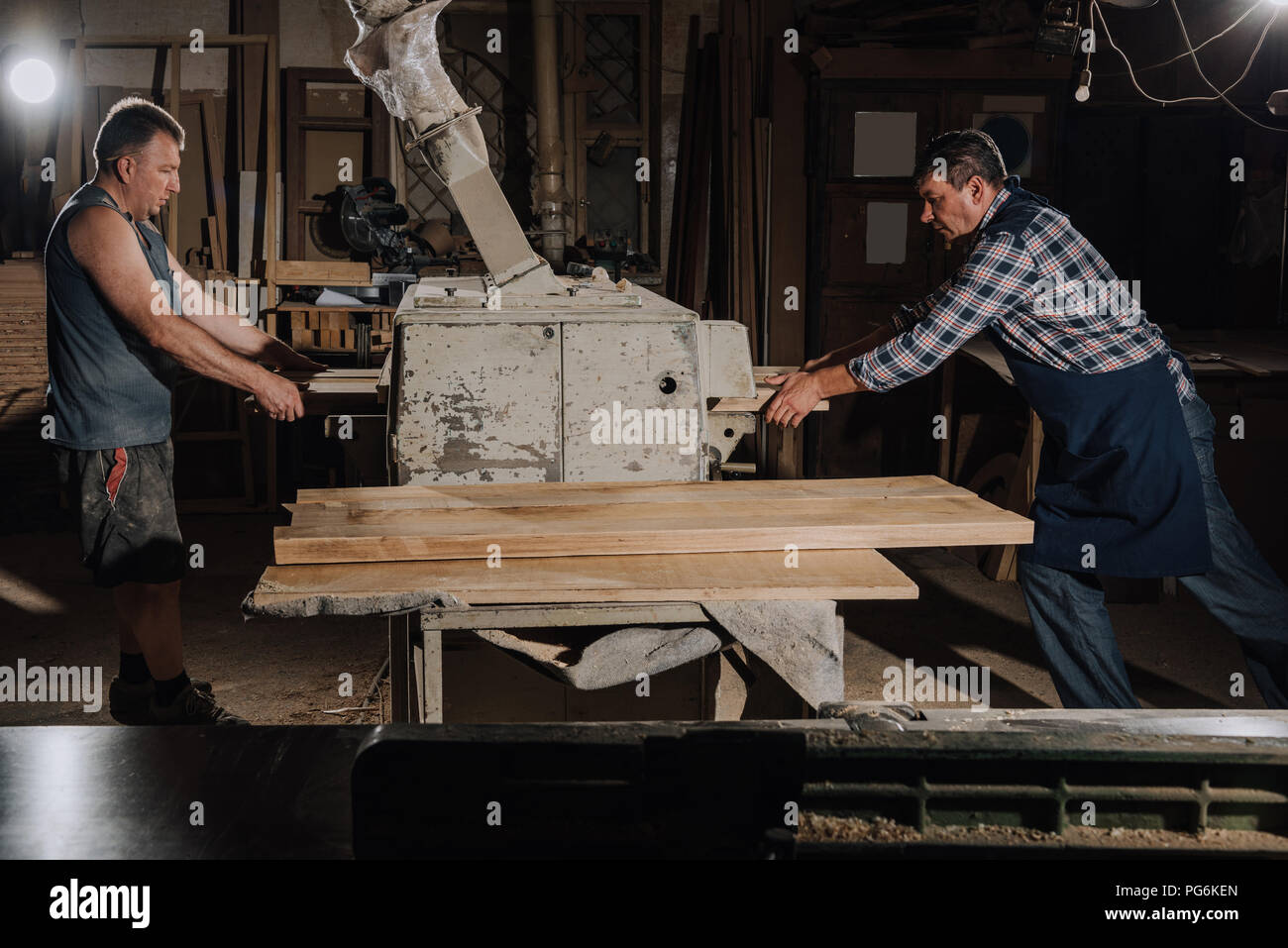 carpenters working with wooden planks at wooden workshop Stock Photo ...