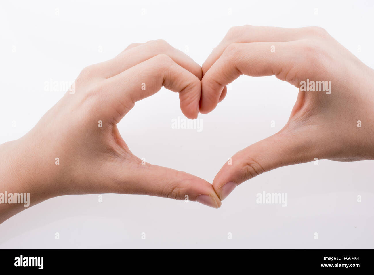 Hand making a heart shape on a white background Stock Photo - Alamy
