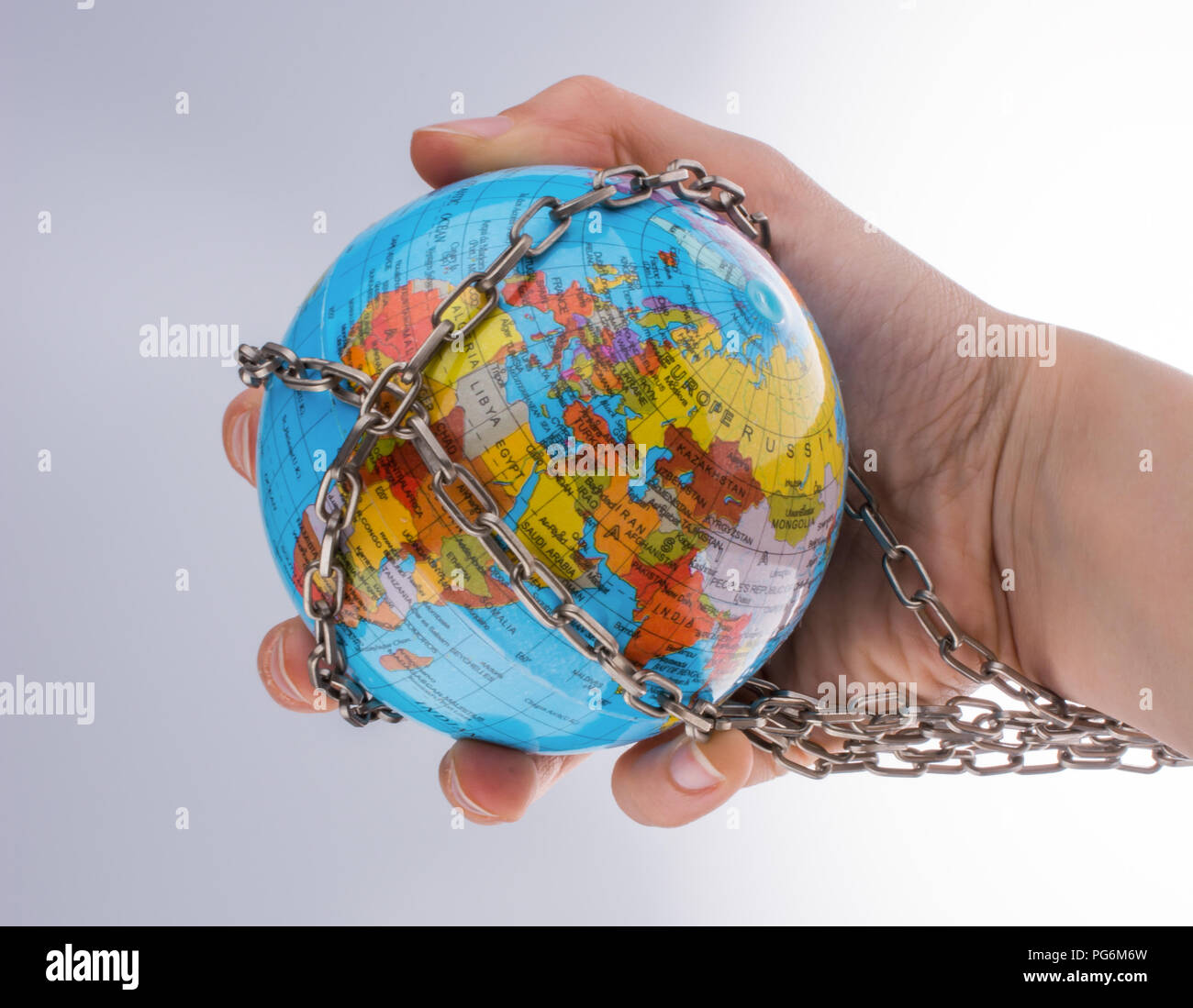 Globe in chain on a white background Stock Photo - Alamy