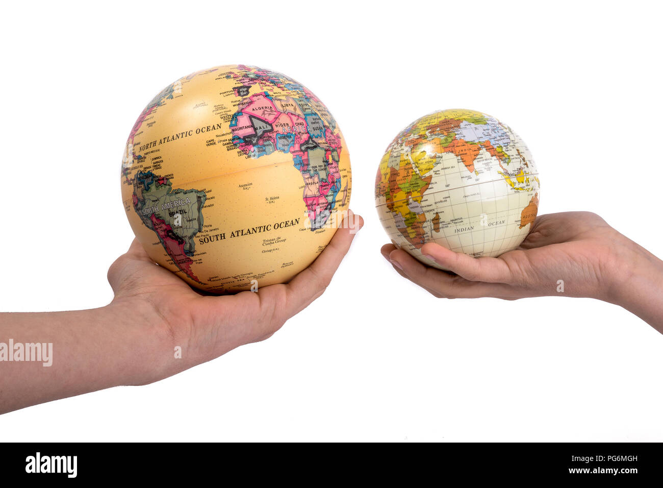 Two hands holding holding two globes in hand on white background Stock ...