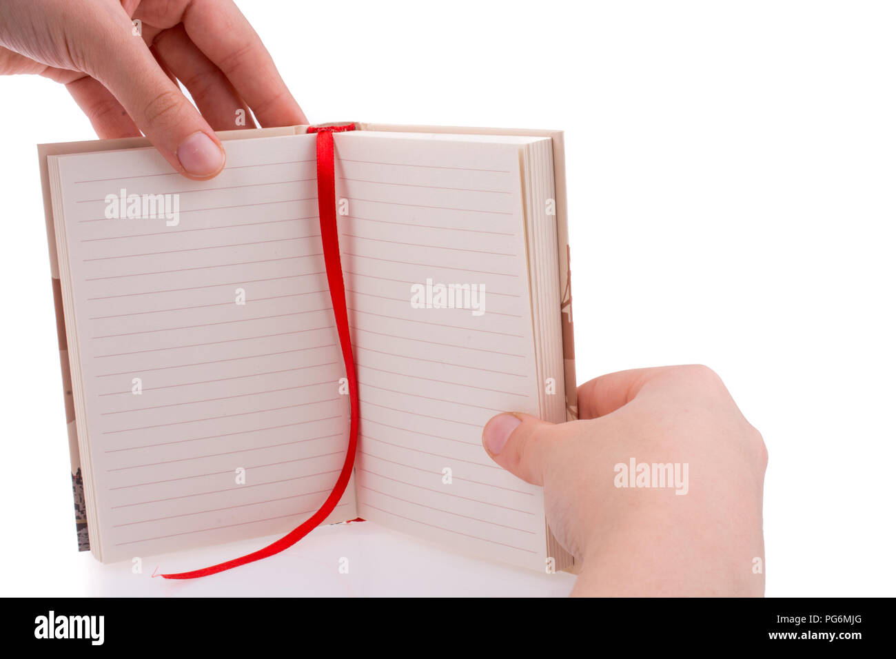 Hand holding a notebook on a white background Stock Photo - Alamy