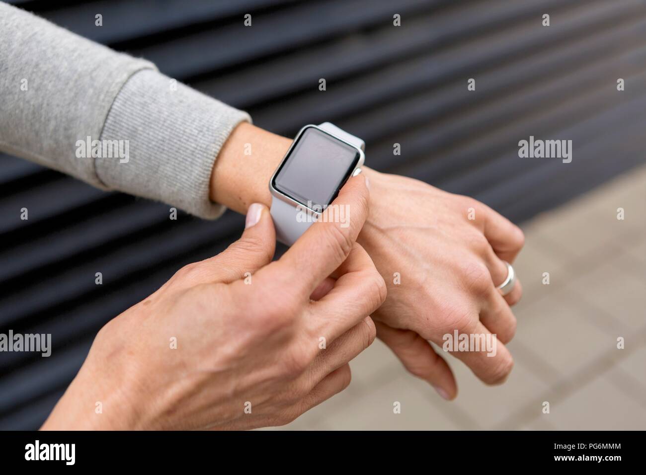 Woman's hand adjusting settings of smartwatch, close-up Stock Photo - Alamy
