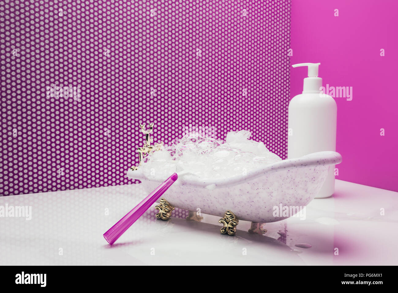 toy bath with real size shaver and lotion bottle in miniature room ...