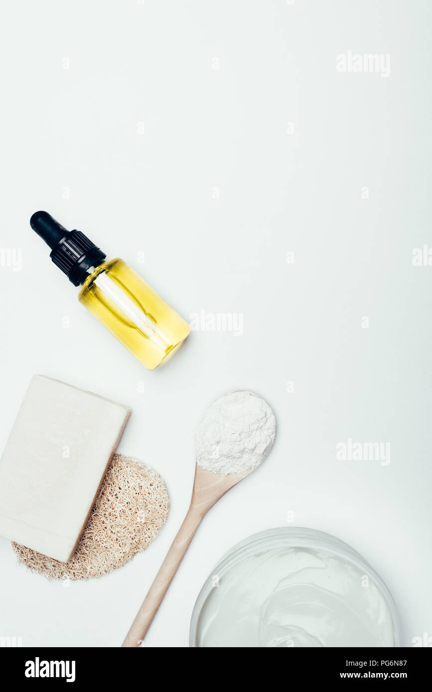 top view of soap, sponge, spoon, clay mask in container and clay powder ...