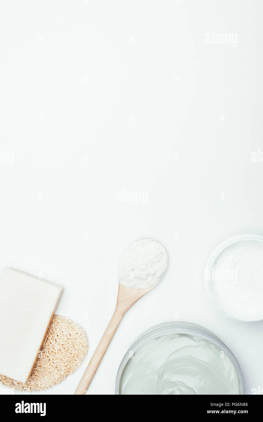 flat lay with soap, sponge, spoon, clay masks in containers and clay ...