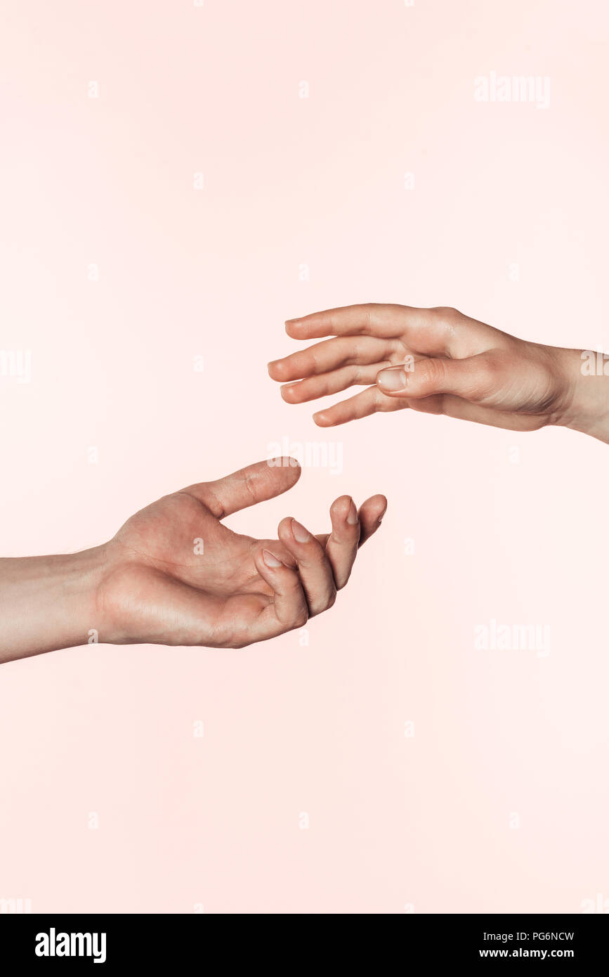 partial view of woman and man approaching hands to each other isolated ...