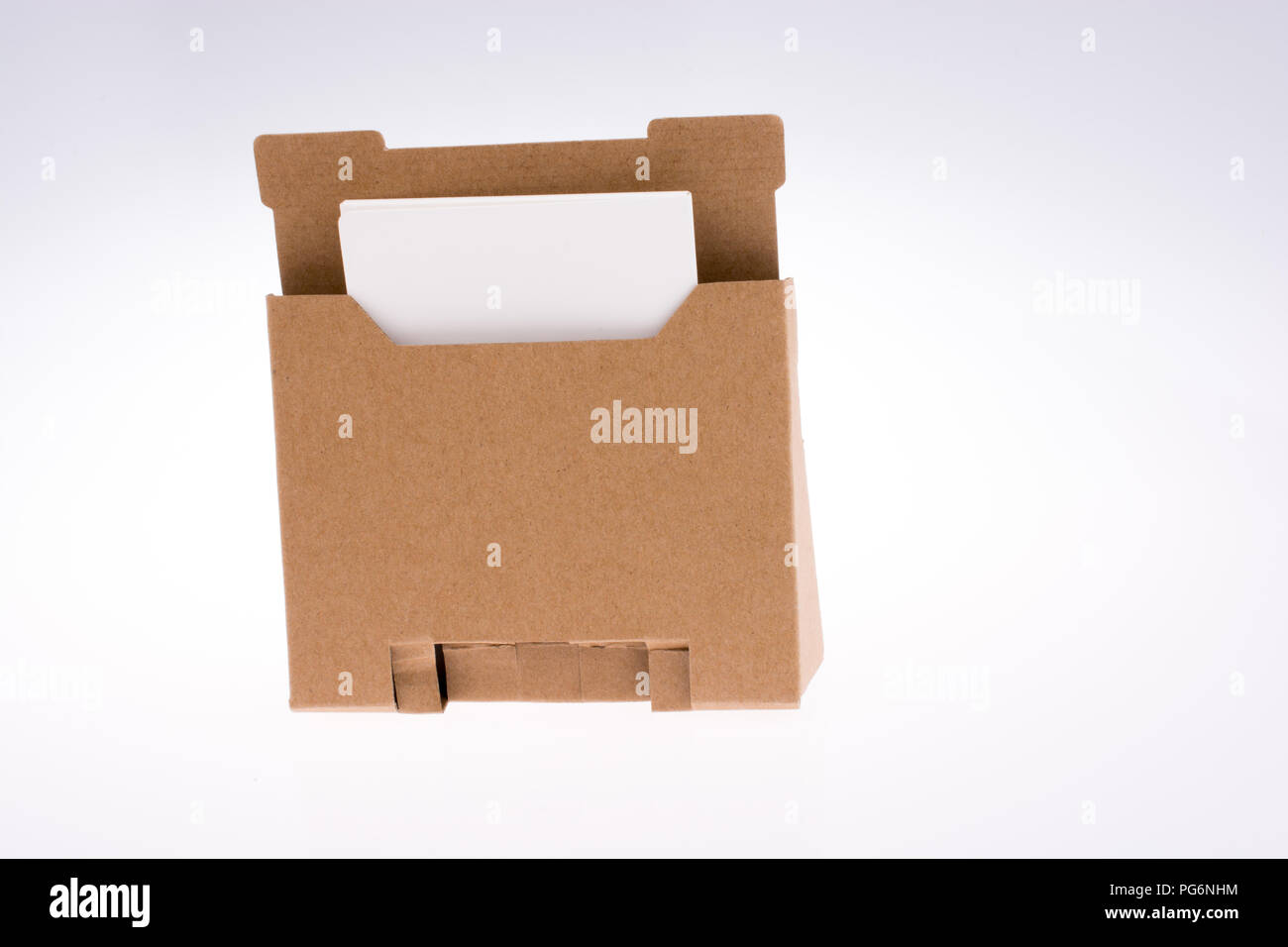 Hand reaches paper holder stand on white background Stock Photo - Alamy