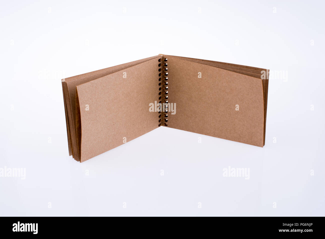 Brown spiral Notebook on a white background Stock Photo - Alamy